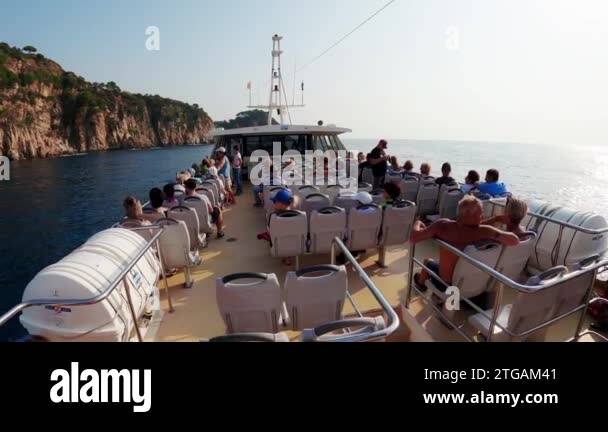 People float on a pleasure boat along the Costa Brava. Boat trip in the ...