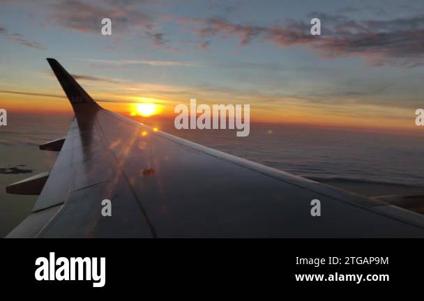 Airplane flying. Wing of an airplane flying above the clouds with ...