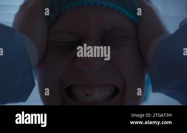 Hurt woman crying in hospital room against window, crying in pain, with ...