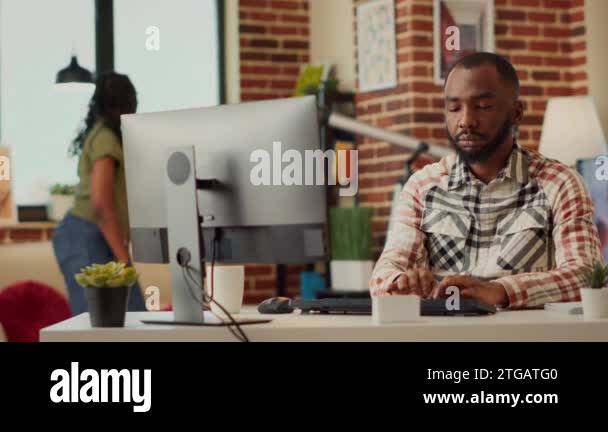 Young man employee doing remote work at home to plan report, using ...