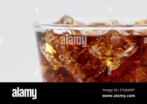 Cola with ice cubes close-up. Cola with Ice in glass. Coke Soda closeup Stock Video Footage - Alamy