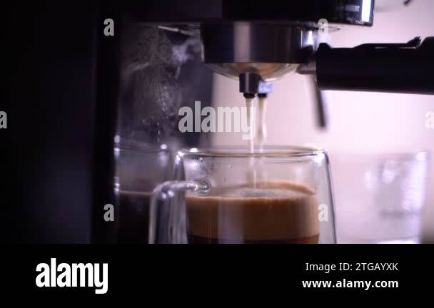 close-up of Coffee foam. espresso crema comes out of the fully ...