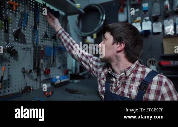 A cycle technician fixes the bicycle chain with a special work tool at ...