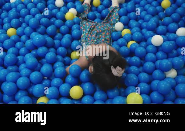 Happy Asian child woman having fun on entertainment center inflatable ...