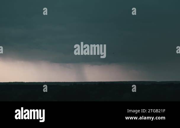 Lightning flash in storm clouds. Heavy clouds bring multiple flashes of ...