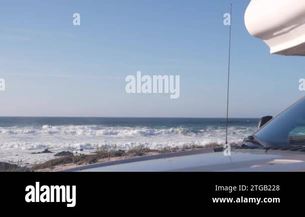 Motorhome trailer, caravan for road trip. Waves of pacific ocean sea ...