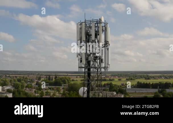 Telecommunication tower 5G near small town and village. Telecom tower antenna and satellite ...