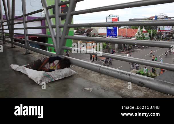 Poor Homeless Boy Kid Sleeping on Pedestrian Bridge in Indonesia Stock ...