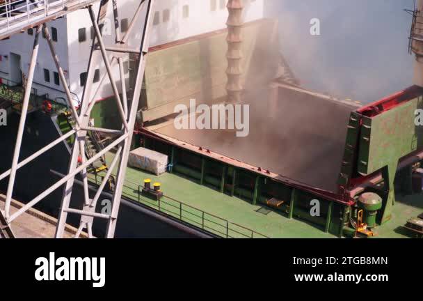 Wheat loading to bulker ship cargo container at sea grain terminal in ...