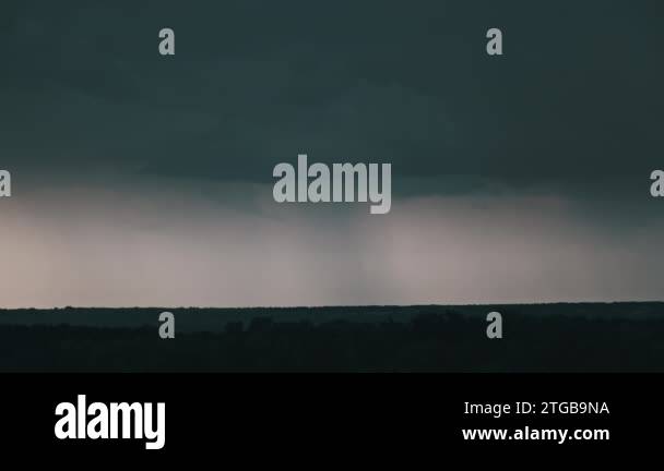 Lightning flash in storm clouds. Heavy clouds bring multiple flashes of ...