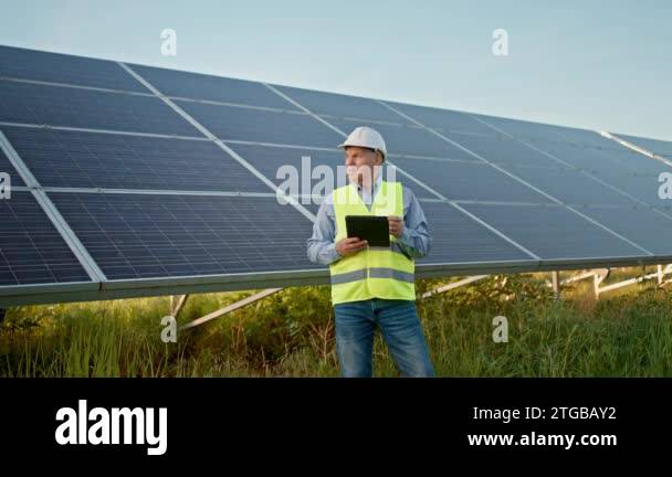 Solar engineer checking photovoltaic panels. Solar farm. 4k Stock Video ...