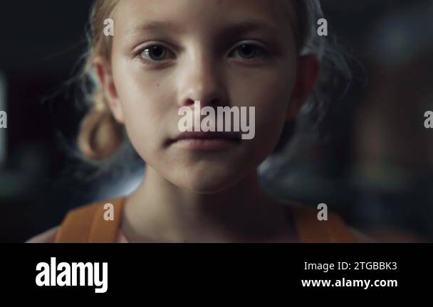 Closeup face little scared girl in dark hall. Frightened preteen ...