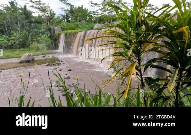 The view at a waterfall whose water is cloudy because it carries mud ...