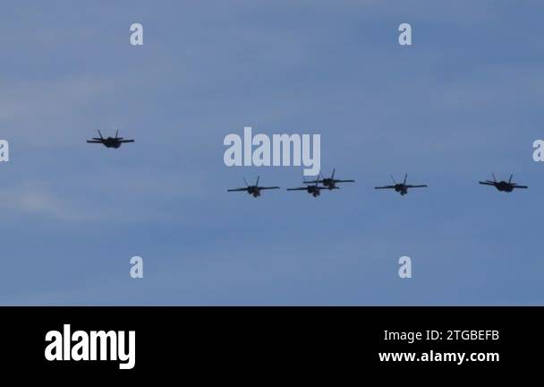 Single stealth fighter jet leave a formation in flight with full ...