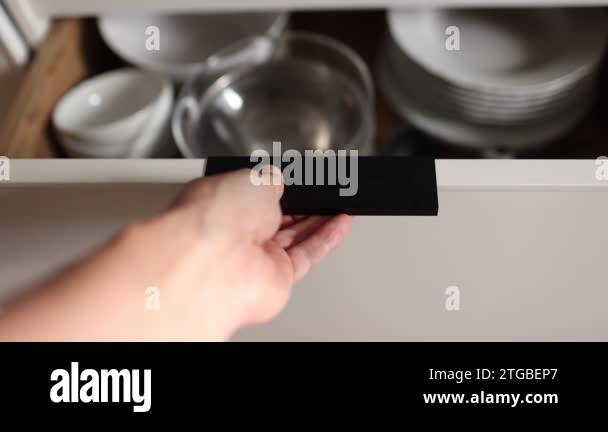 close the drawer in the kitchen. modern kitchen cabinet, man close ...