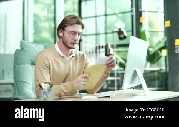 Happy young business man office worker with glasses received opening ...