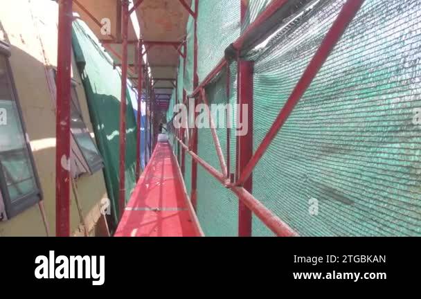 Scaffolding around the building. POV from above scaffolding ...