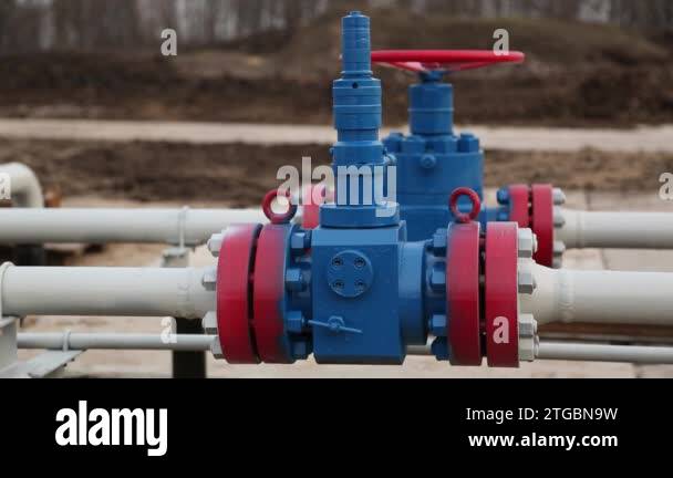 Oil and gas pumping production. Large blue refinery pipes with flanges ...