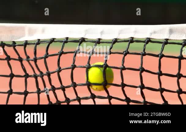 Super Slow Motion Shot of Tennis Ball Hitting the Net on Court at ...