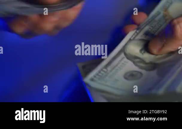 Male hands checks US Dollar bills or counting in cash against the ...