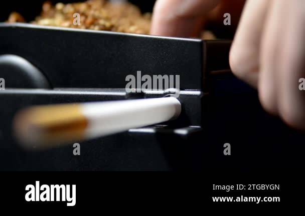 The process of putting tobacco into cigarette cases with a semi ...