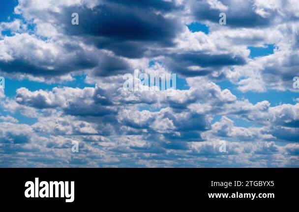 Timelapse of cumulus clouds moving in the blue sky. Light layered ...