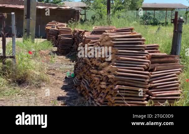 Heap of unnecessary dismantled roof tiles on construction side, mossed ...