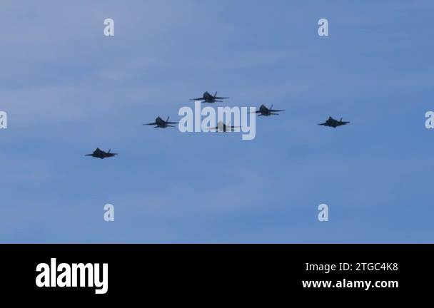 Modern fighter jet aircraft in flight in formation with one that ...