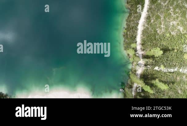 Aerial Lake, top down view of path next to shoreline of beautiful ...