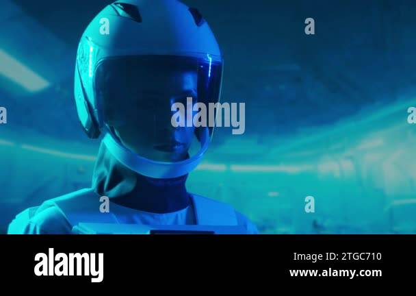 A woman astronaut in a space suit aboard the orbital station. A young ...