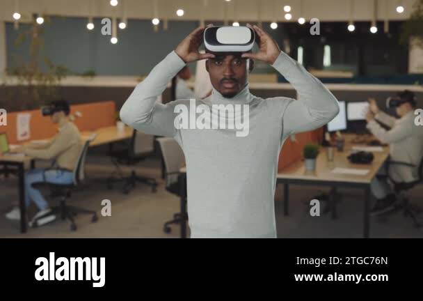 Office male worker wearing a VR headset, virtual reality concept ... Office male worker wearing a VR headset, virtual reality concept ...