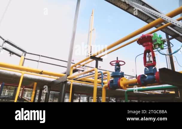 Gas extraction station. Pipes with valves and fuel storage tanks ...