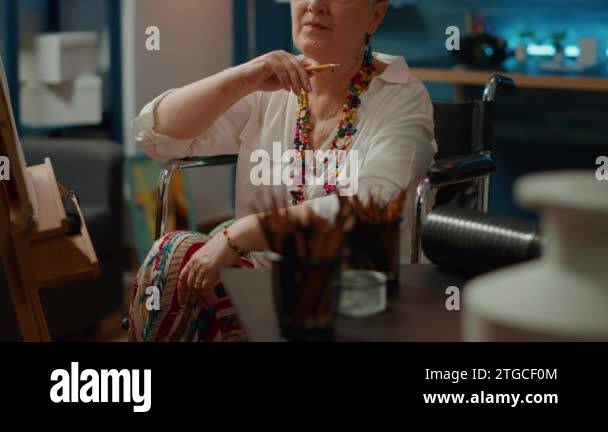 Old woman living with physical disability and drawing masterpiece on ...