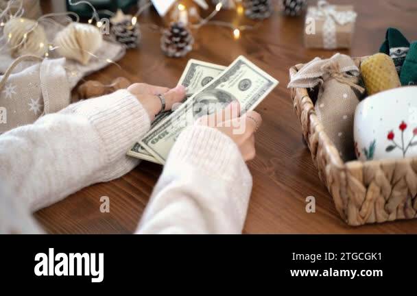 Girl counting US Dollar bills, and planning expenses for Christmas ...