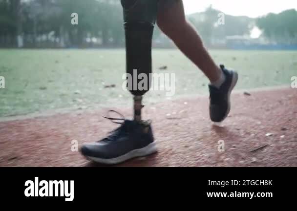 Amputee athlete running with prosthetic leg. Disabled runner with ...