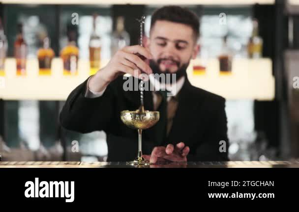 Caucasian man making exclusive alcoholic cocktail at bar counter using ...