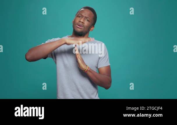 Serious tired person advertising timeout symbol with hands, doing t ...