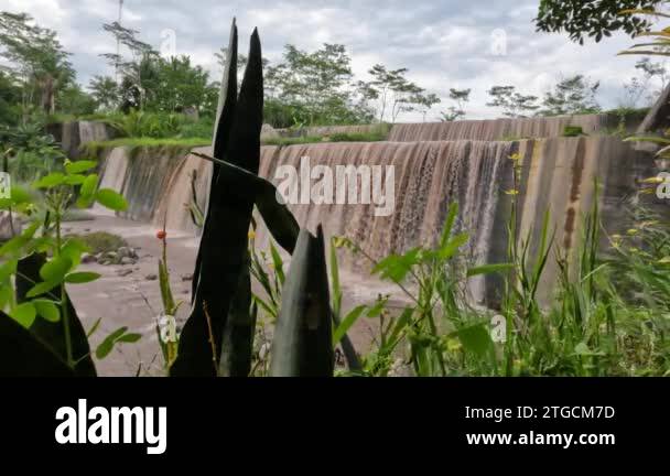 The view at a waterfall whose water is cloudy because it carries mud ...