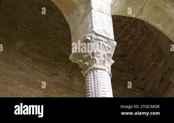 Ancient church arched window with column in a Roman style. Old medieval ...