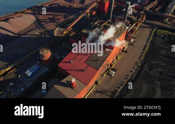 Urban area of steel factory manufacturing during sunset golden hour ...