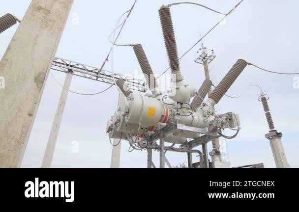 New modern, high voltage equipment with insulators and power wires at a ...