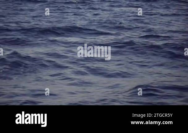 Blue ocean sea water wave with fast yacht boat wake foam of prop wash ...