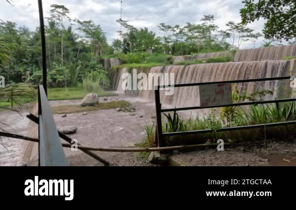 The view at a waterfall whose water is cloudy because it carries mud ...