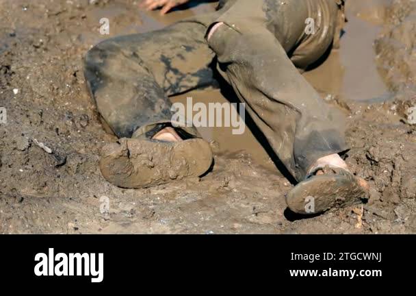 An alcoholic man lies in the swamp. The legs of a homeless man who fell ...