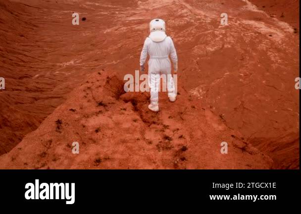 Unrecognisable astronaut back waving hands asking for help on Mars ...