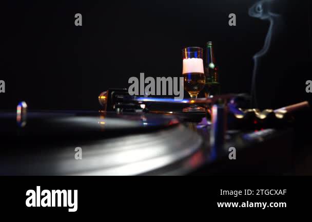 DJ Turntable Spinning With Vinyl Record, Cigarette Smoke, Beer Glass ...