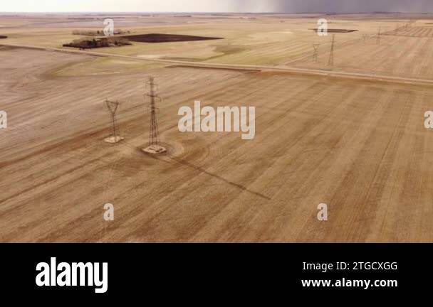 High aerial tilt reveal of Transmission lines and power poles on the ...