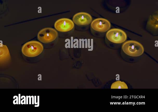 Static esoteric candles with chakra symbols. Mystic crystals and ...