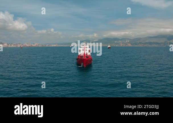 Harbor scene from a drone. Anchored vessels including cargo container ...