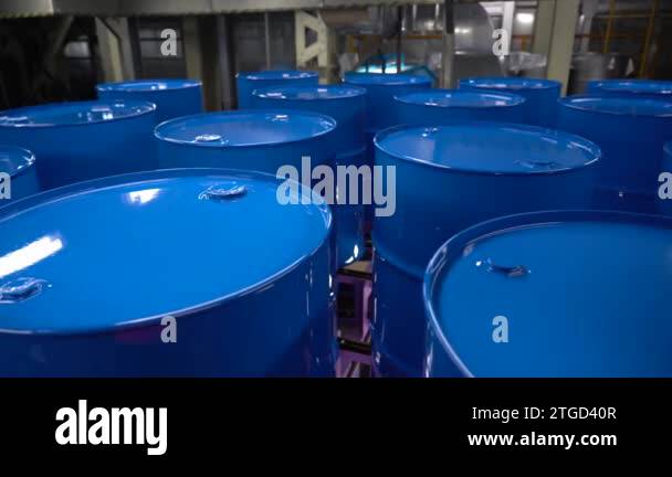 Machine oil production plant. Metal barrel with engine oil. Conveyor ...